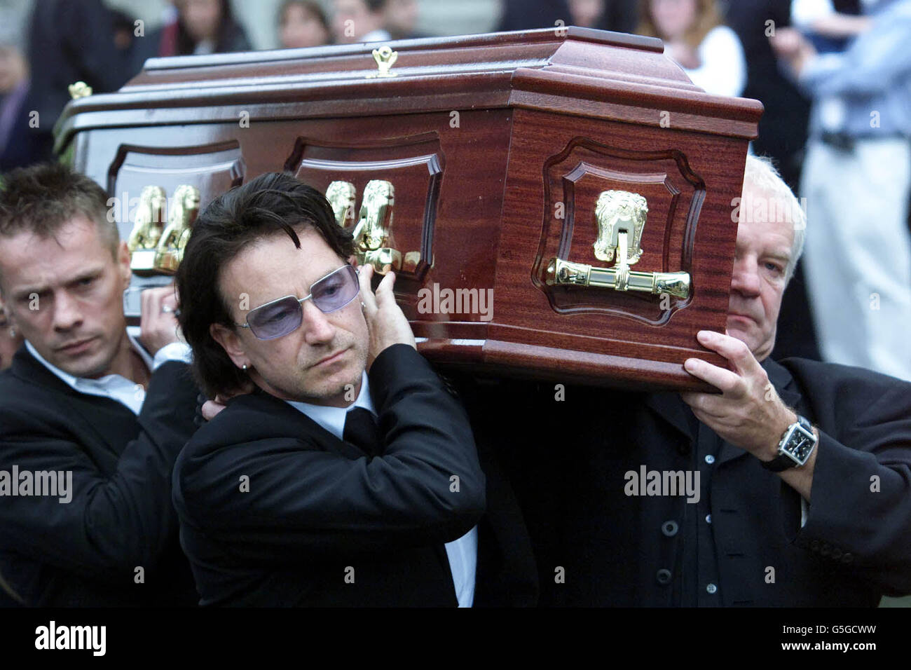 Lead singer of U2 Bono helps carry his father Bob Hewson's coffin, at ...