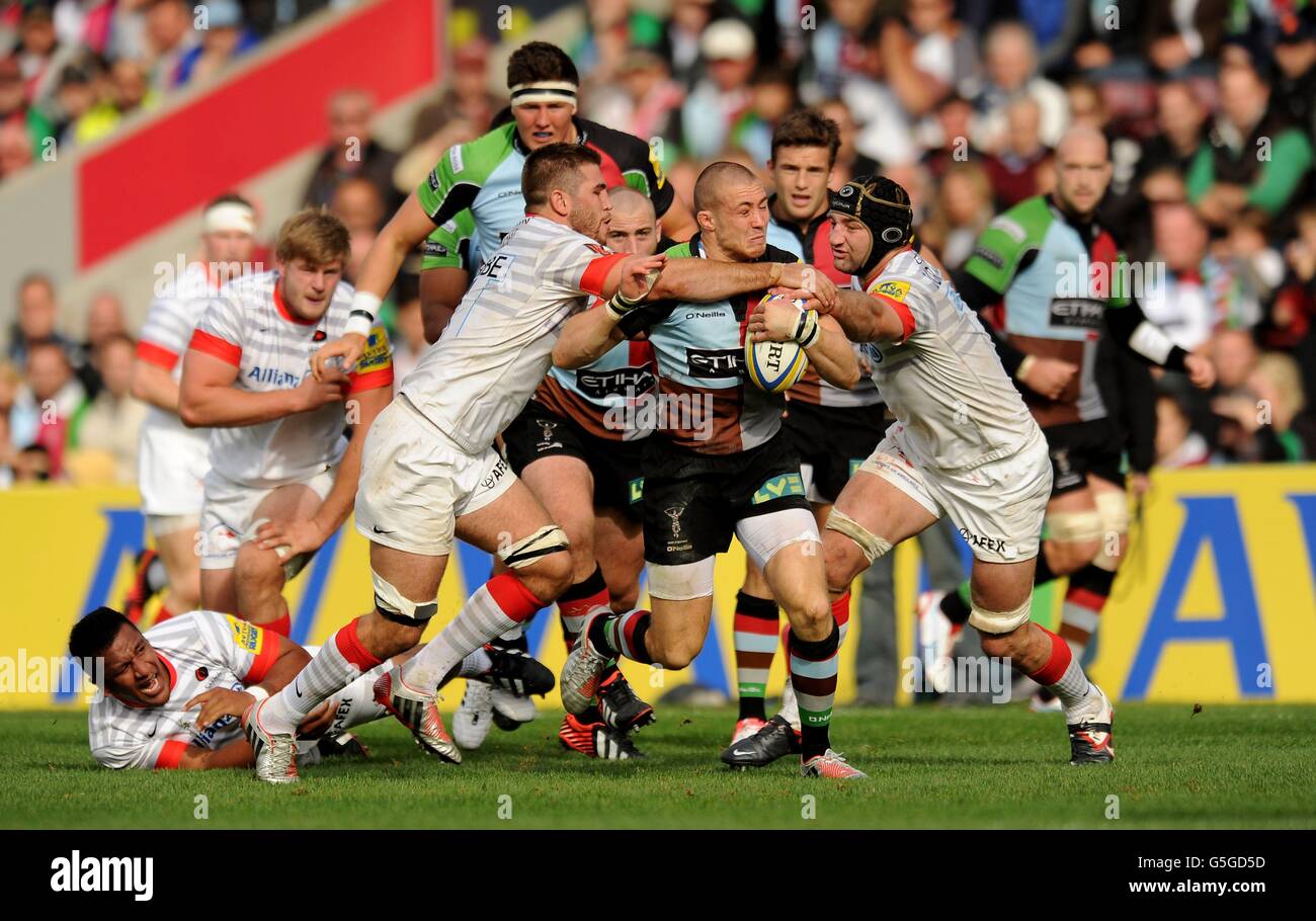 Harlequins' Mike Brown breaks through a tackle from Saracens' Will ...