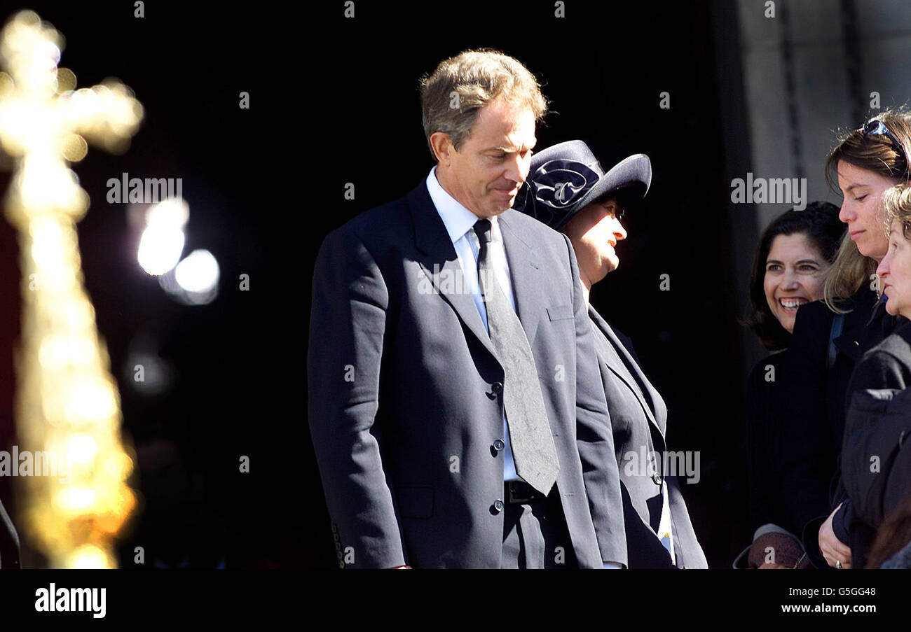 Prime Minister Tony Blair looks down as wife Cherie chats with mourners as they leave St Paul's ...