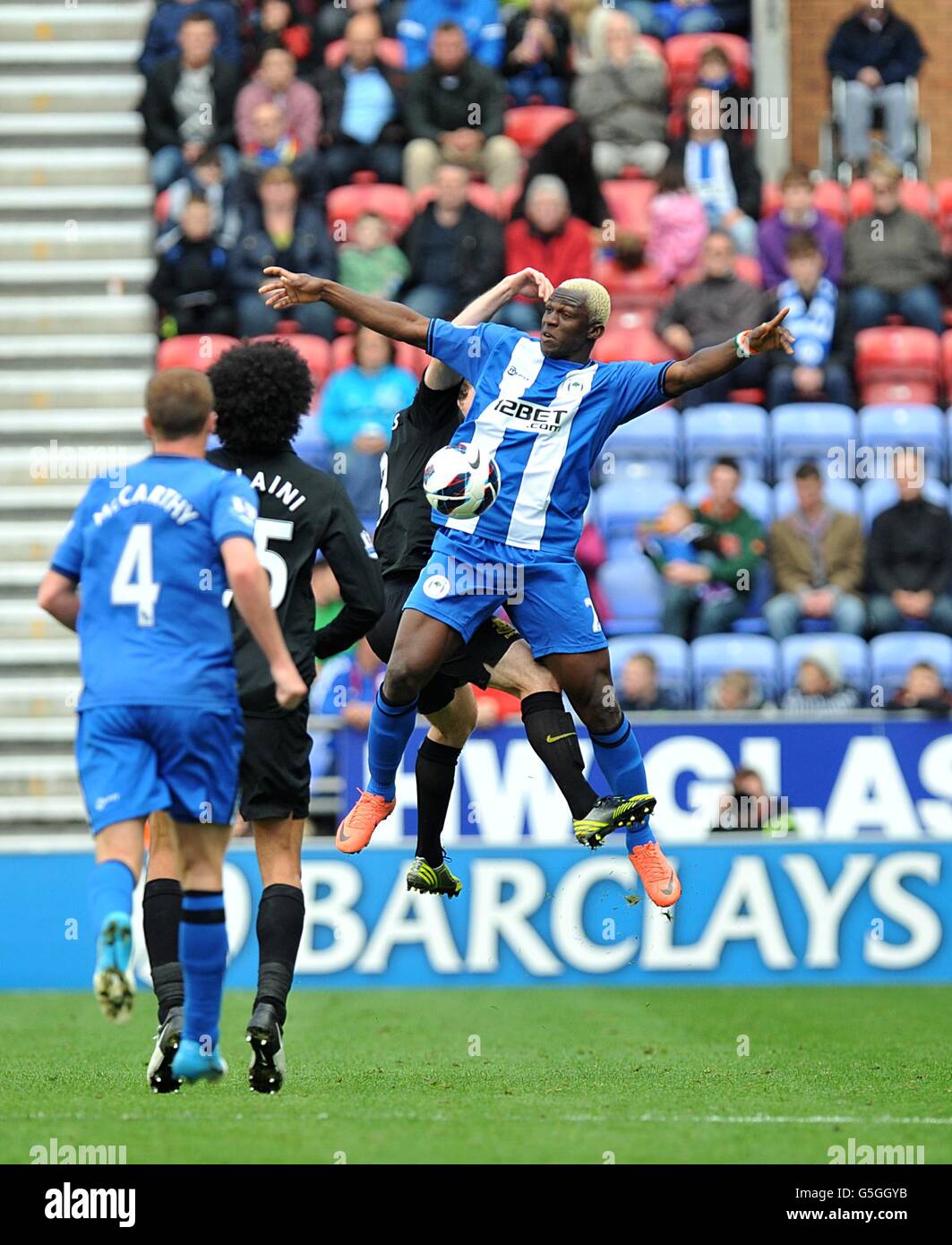 Everton's Leighton Baines (background) and Wigan Athletic's Arouna Kone ...
