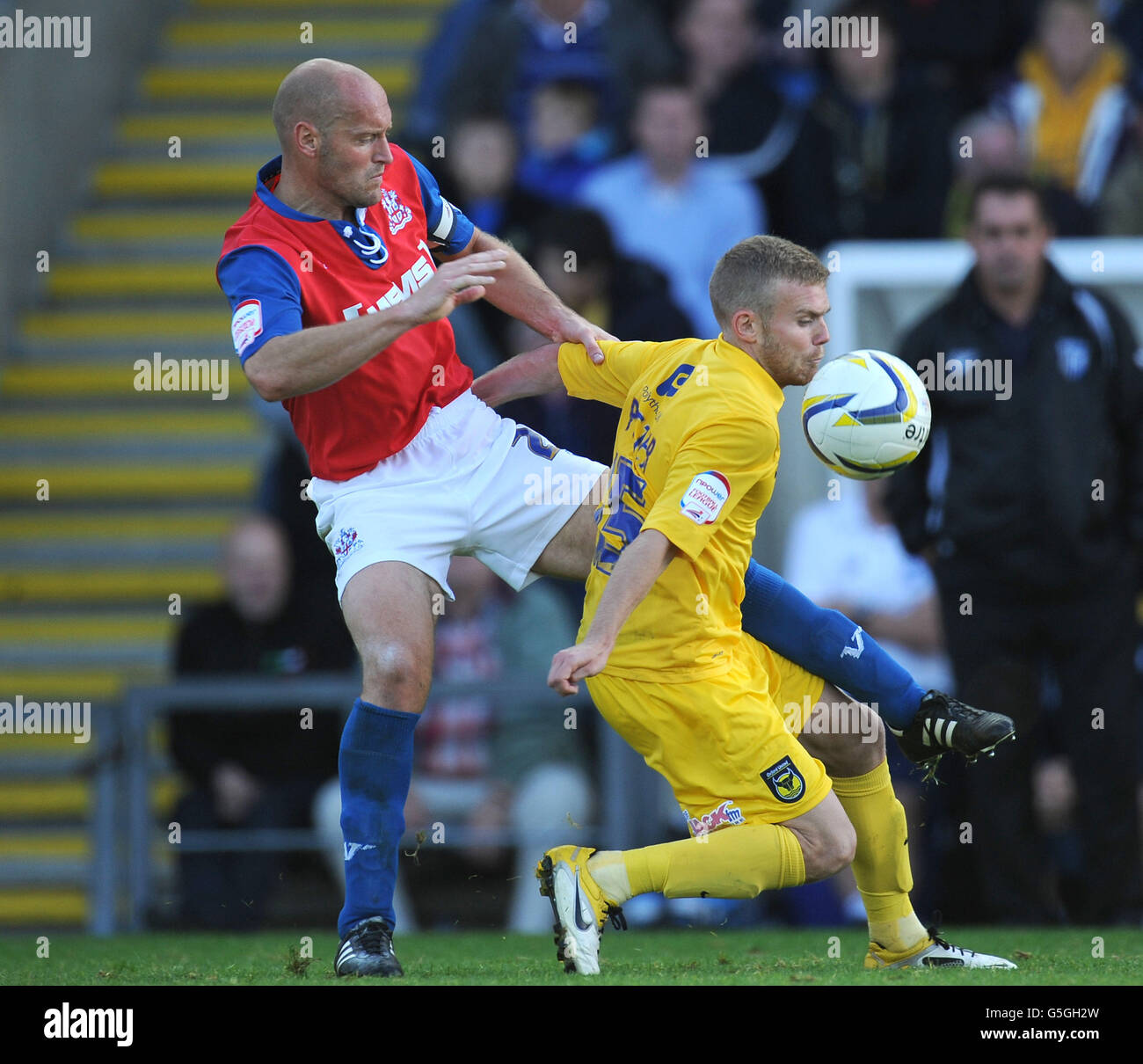 Oxford United's Alfie Potter (right) and Gillingham's Adam Barrett ...