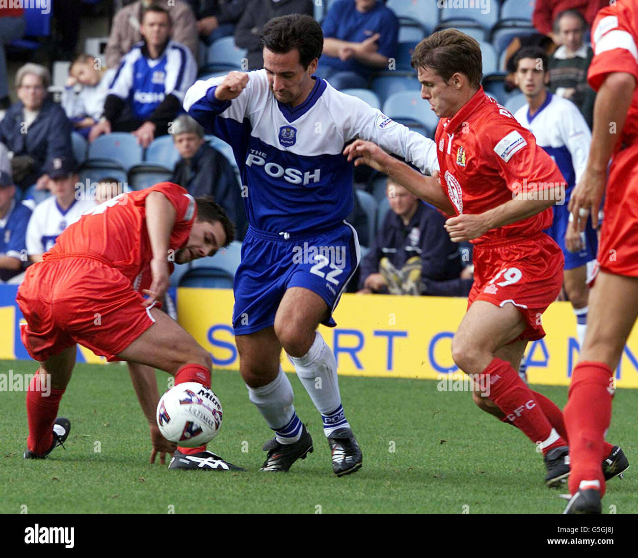 Peterborough's Neale Fenn (centre) breaks through as he comes under ...