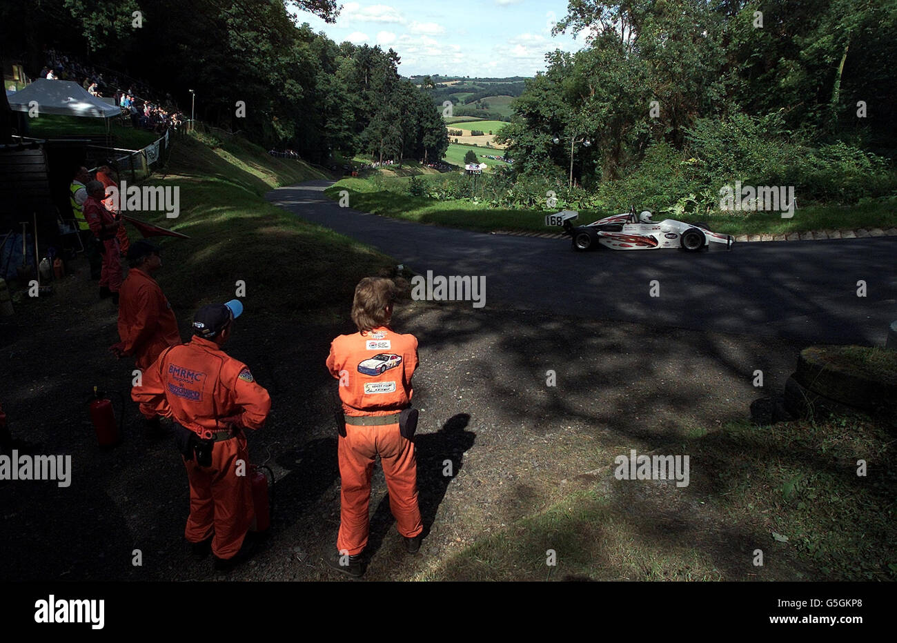 Paul Ranson in his Pilbeam MP82-01. Marshalls keep an eye on Paul ...
