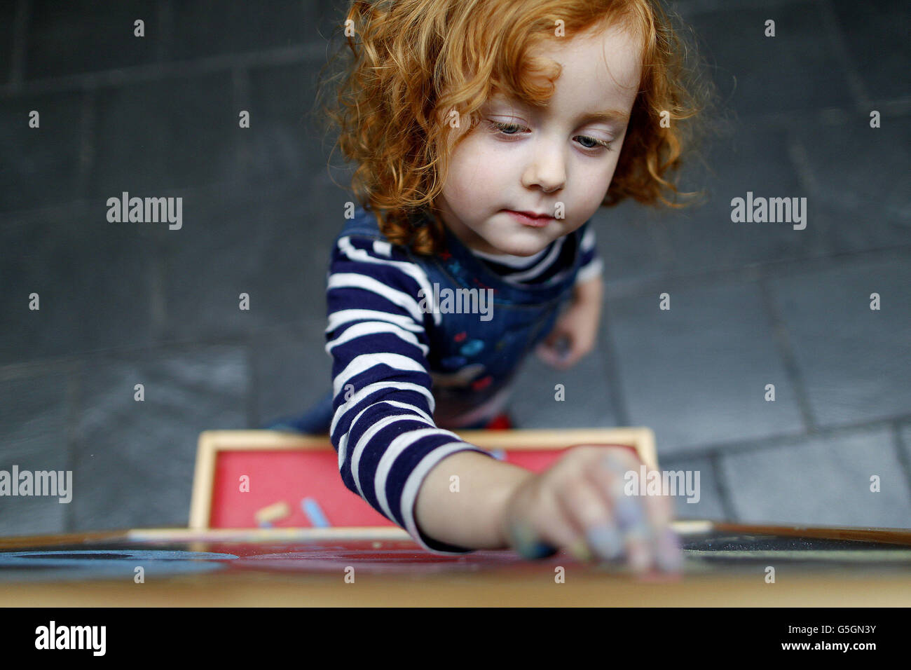 Three year old Isobel McKinley from Dublin chalks a yes onto the ...