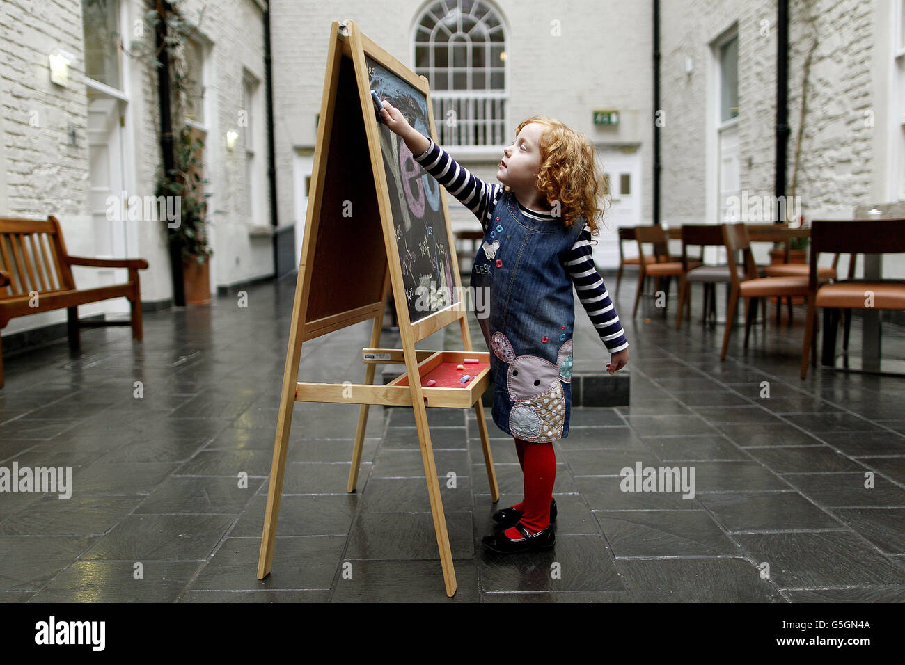 Three year old Isobel McKinley from Dublin chalks a yes onto the ...
