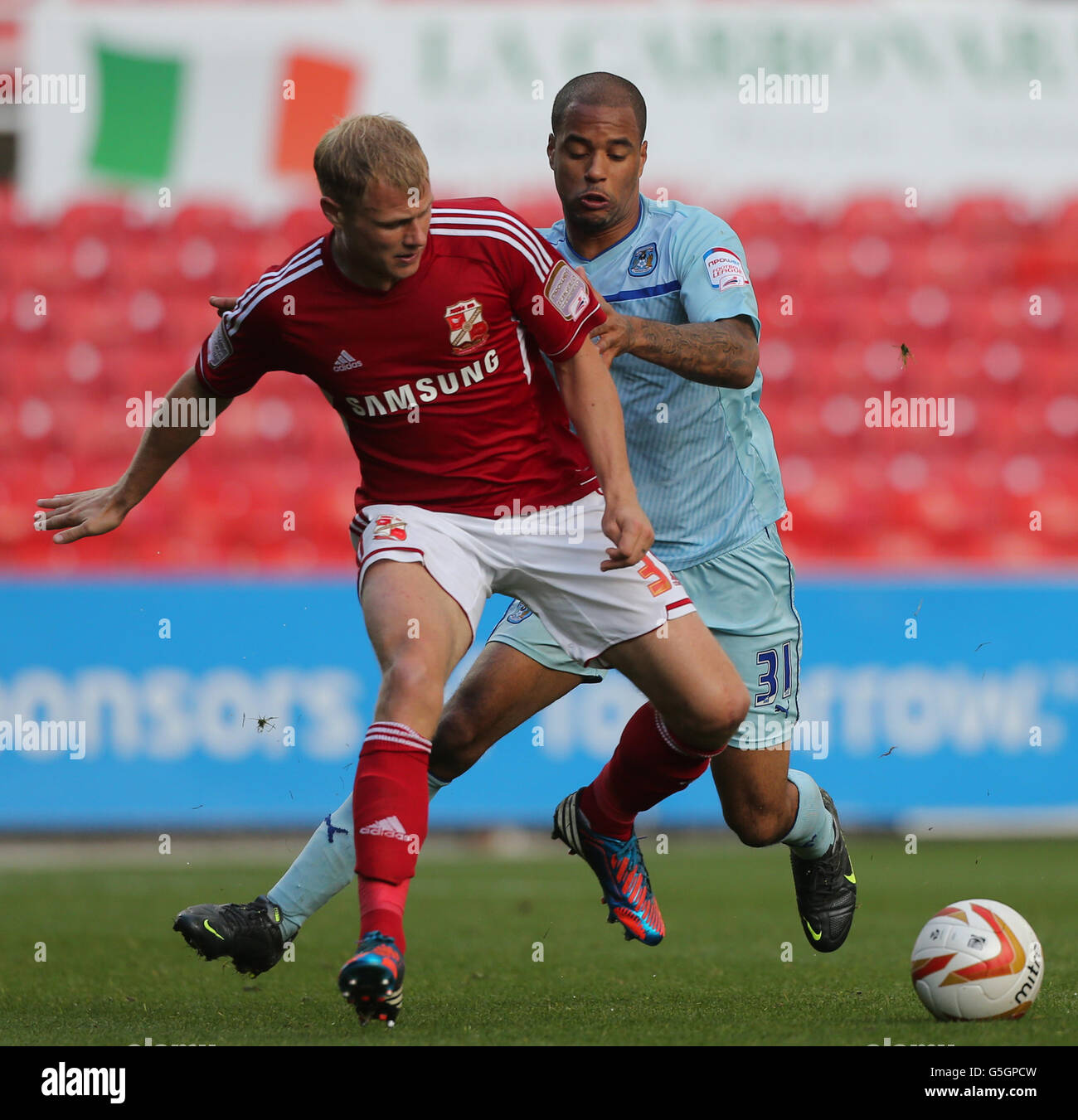 Swindon Town's Jay McEveley tussles with Coventry City's David ...