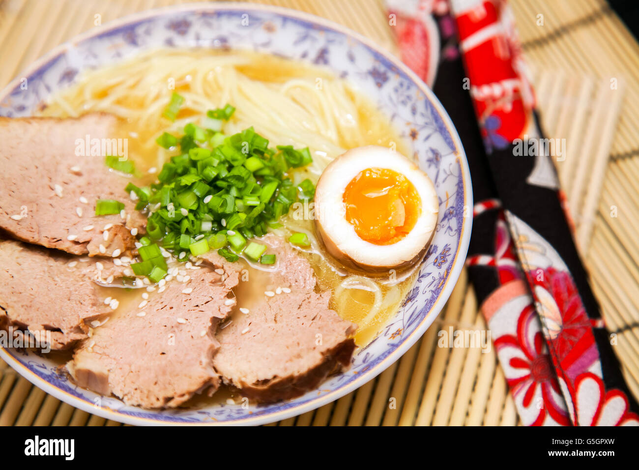Salt ramen garnished with meat, egg and spring onion Stock Photo - Alamy