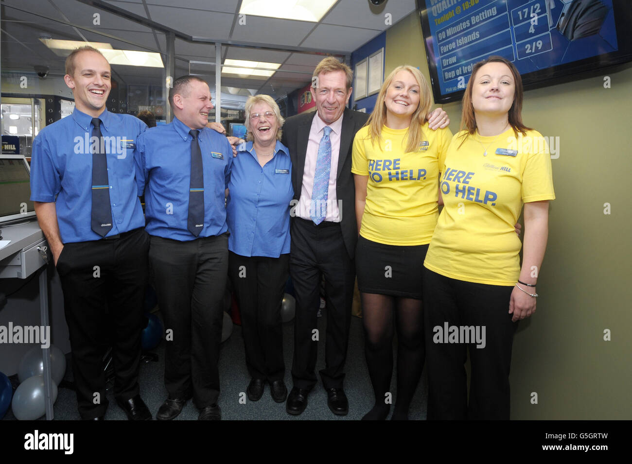 TV racing personality Derek Thompson (centre) poses for a picture with ...