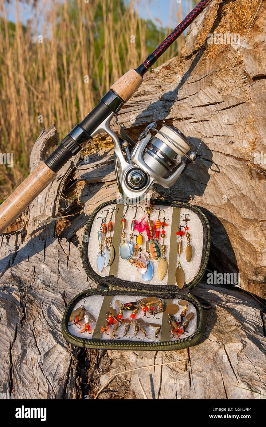 Fishing rod with fishing reel on the natural background. Assorted of ...