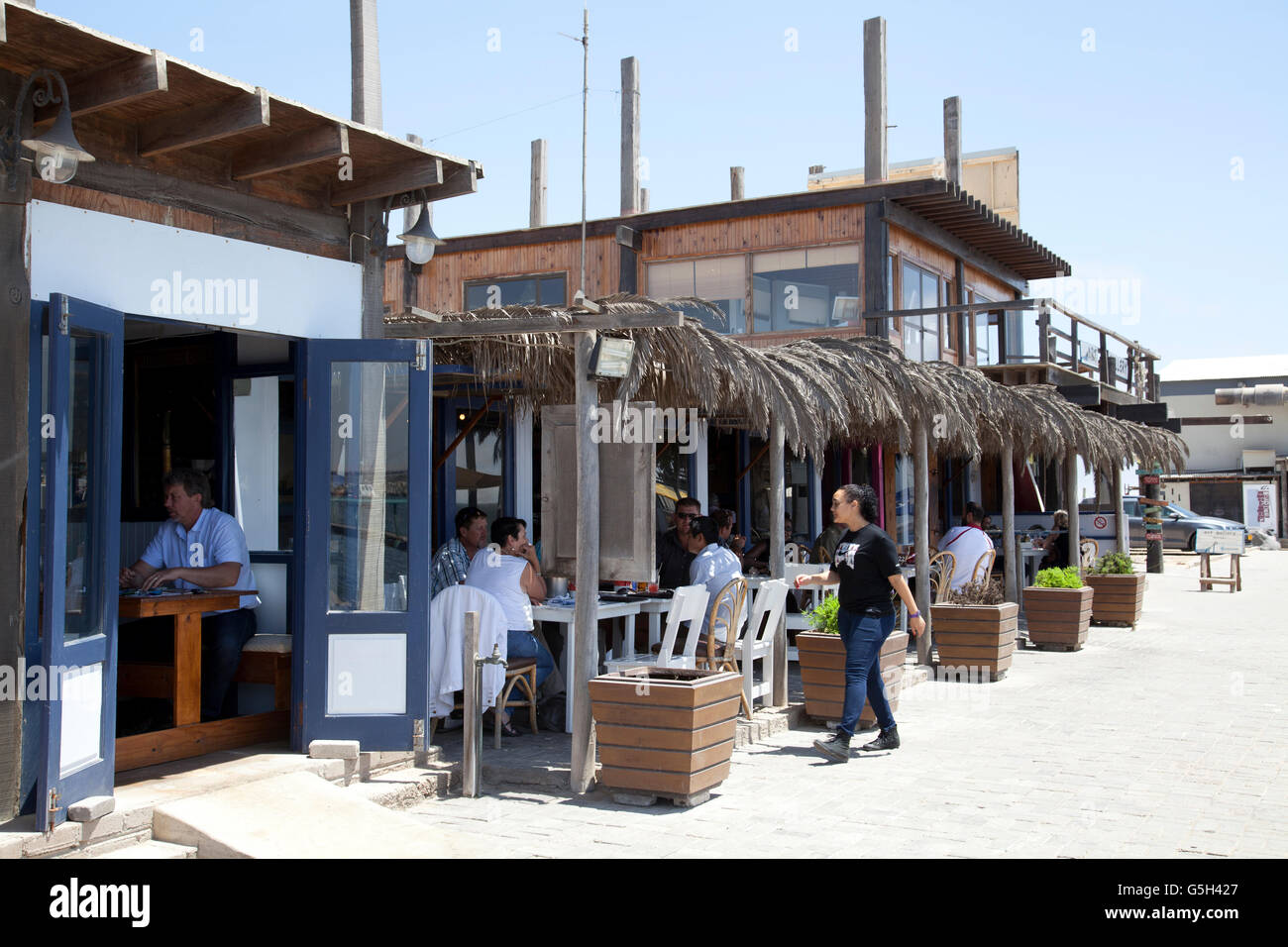 Anchors Restaurant with Diners on Walvis Bay waterfront in Namibia ...