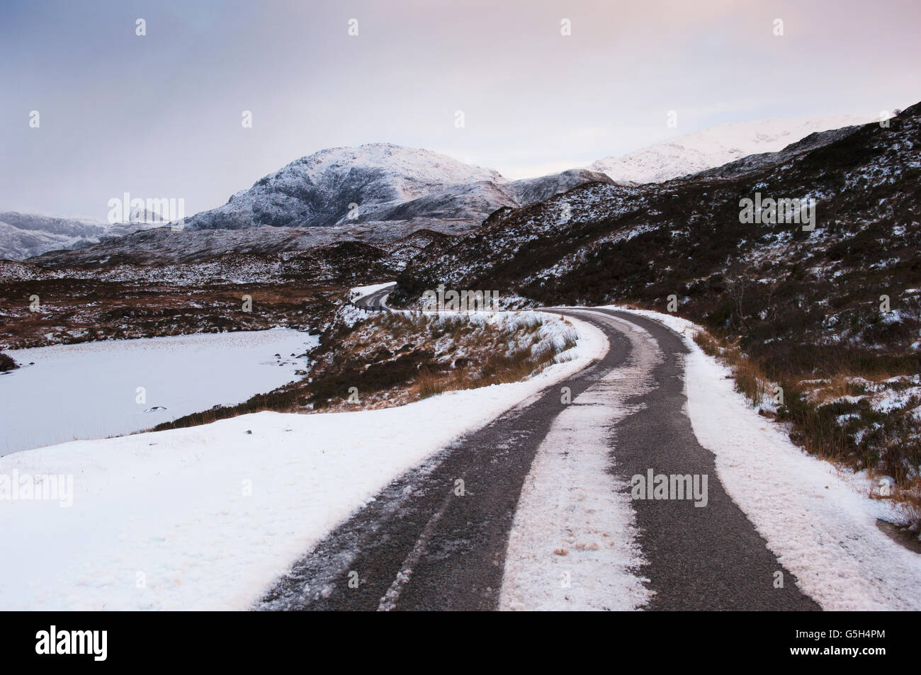 Remote Highland road in winter - Sutherland, Scotland. This road is ...