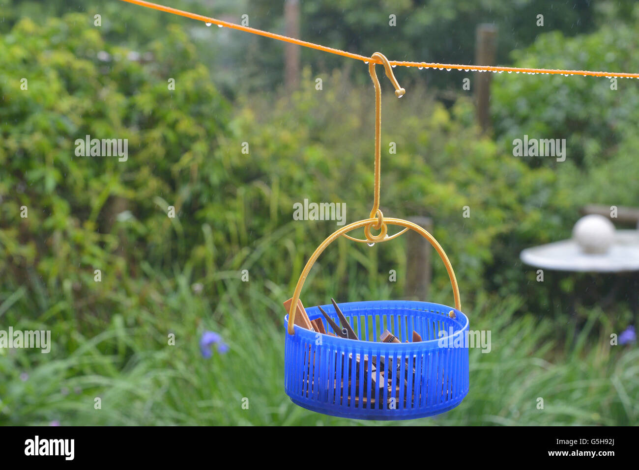 Washing line and clothes peg bag in the rain. England. UK Stock Photo ...