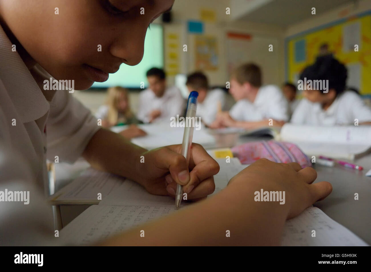 Maths teacher in a secondary school classroom with pupils. England. UK ...