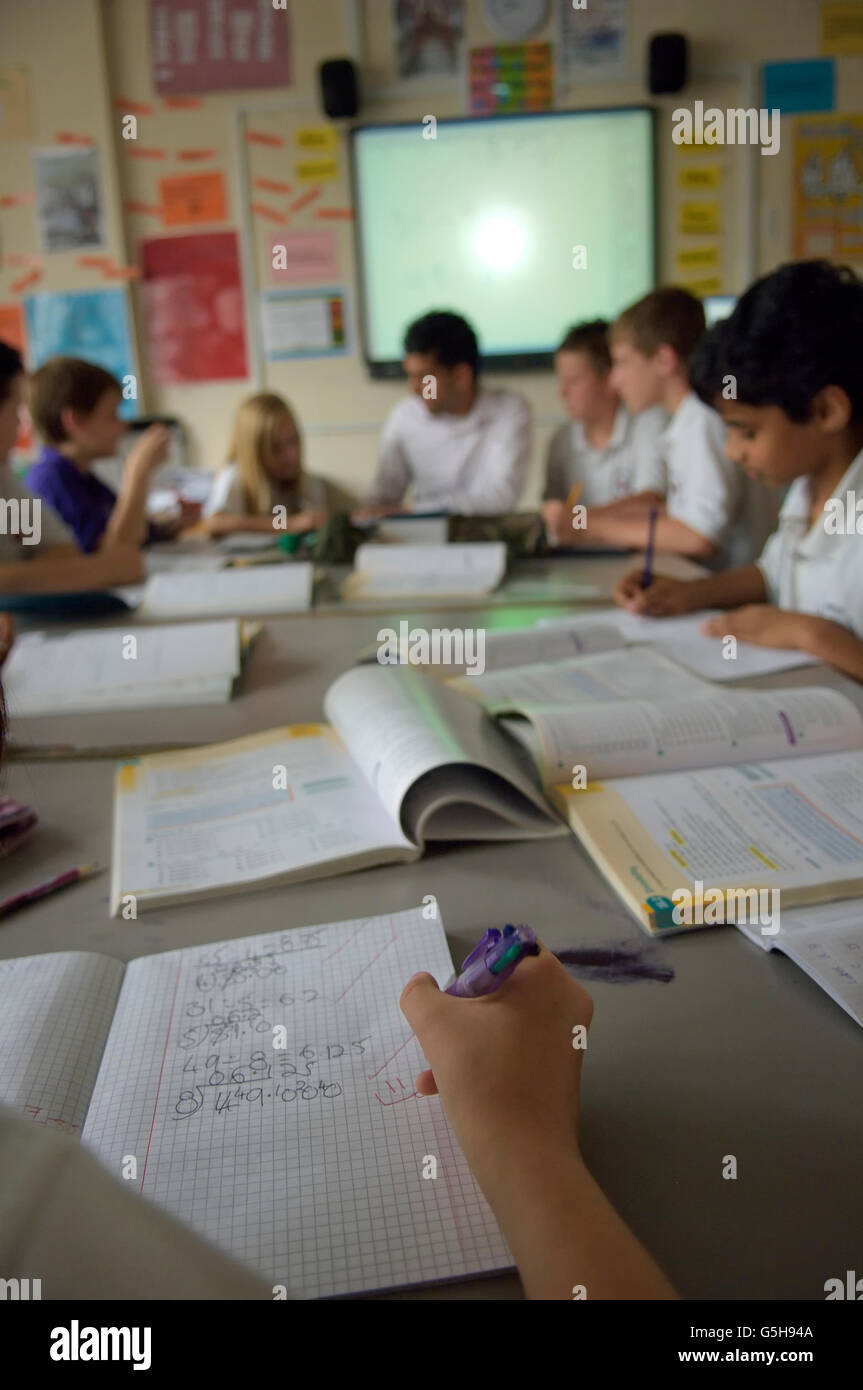Maths teacher in a secondary school classroom with pupils. England. UK ...