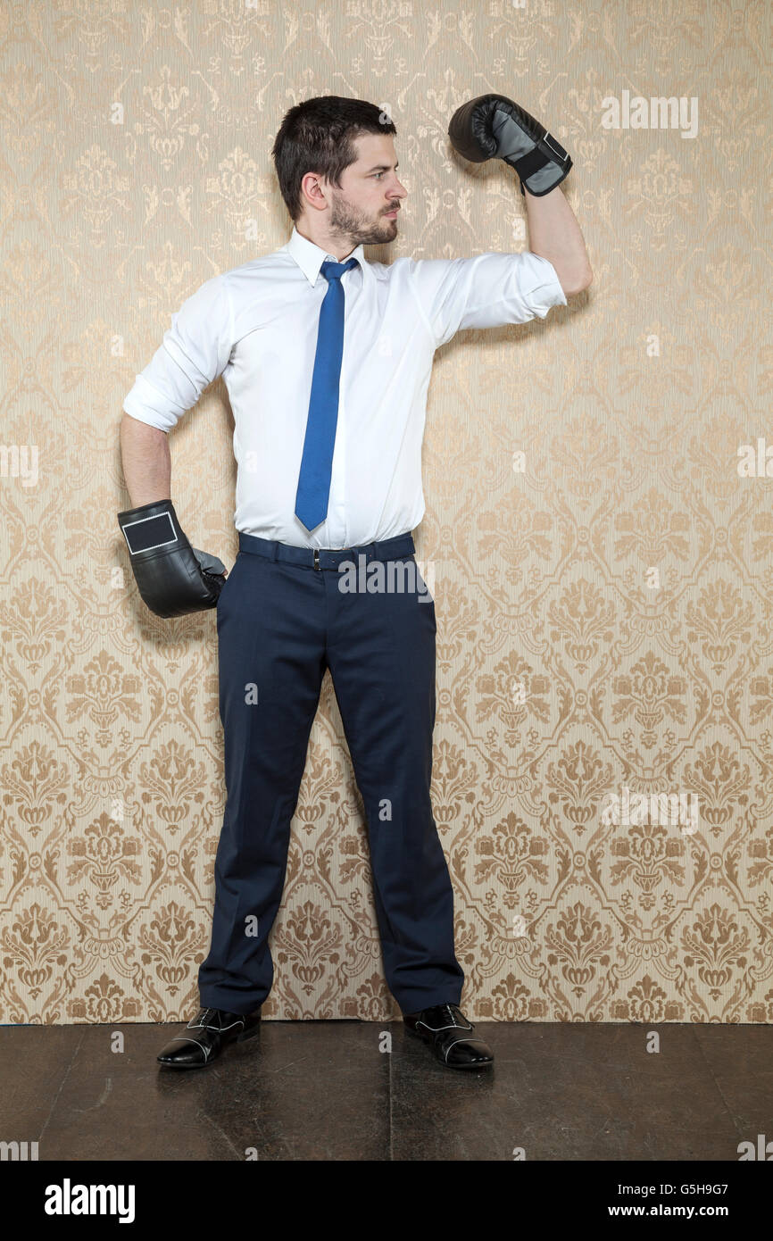 strong businessman shows muscle Stock Photo - Alamy