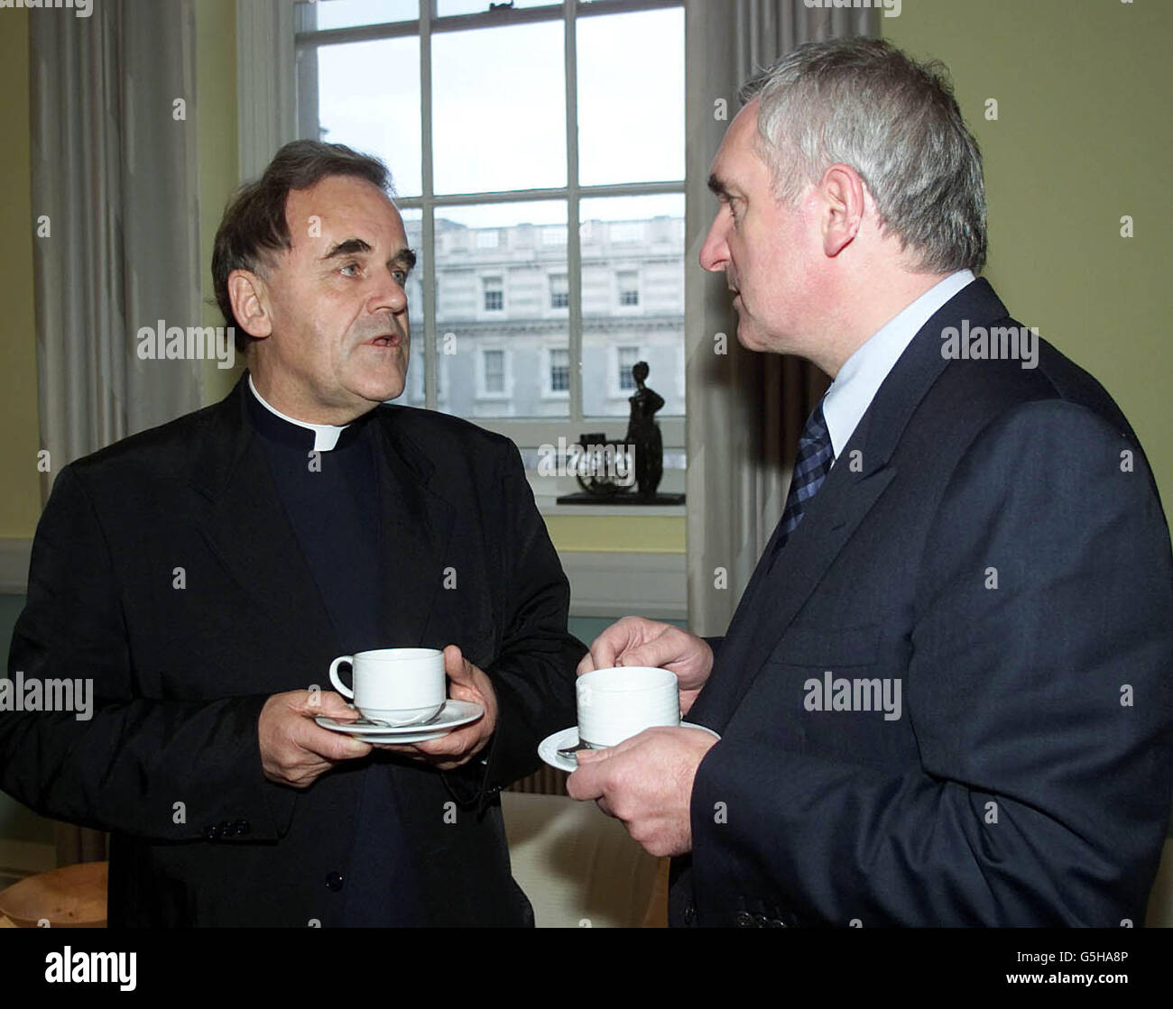 Irish Prime Minister Bertie Ahern talks with Father Aidan Troy, the ...