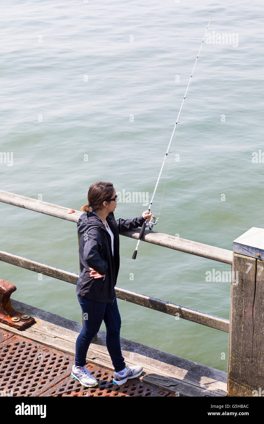Woman fishing off beach hi-res stock photography and images - Alamy