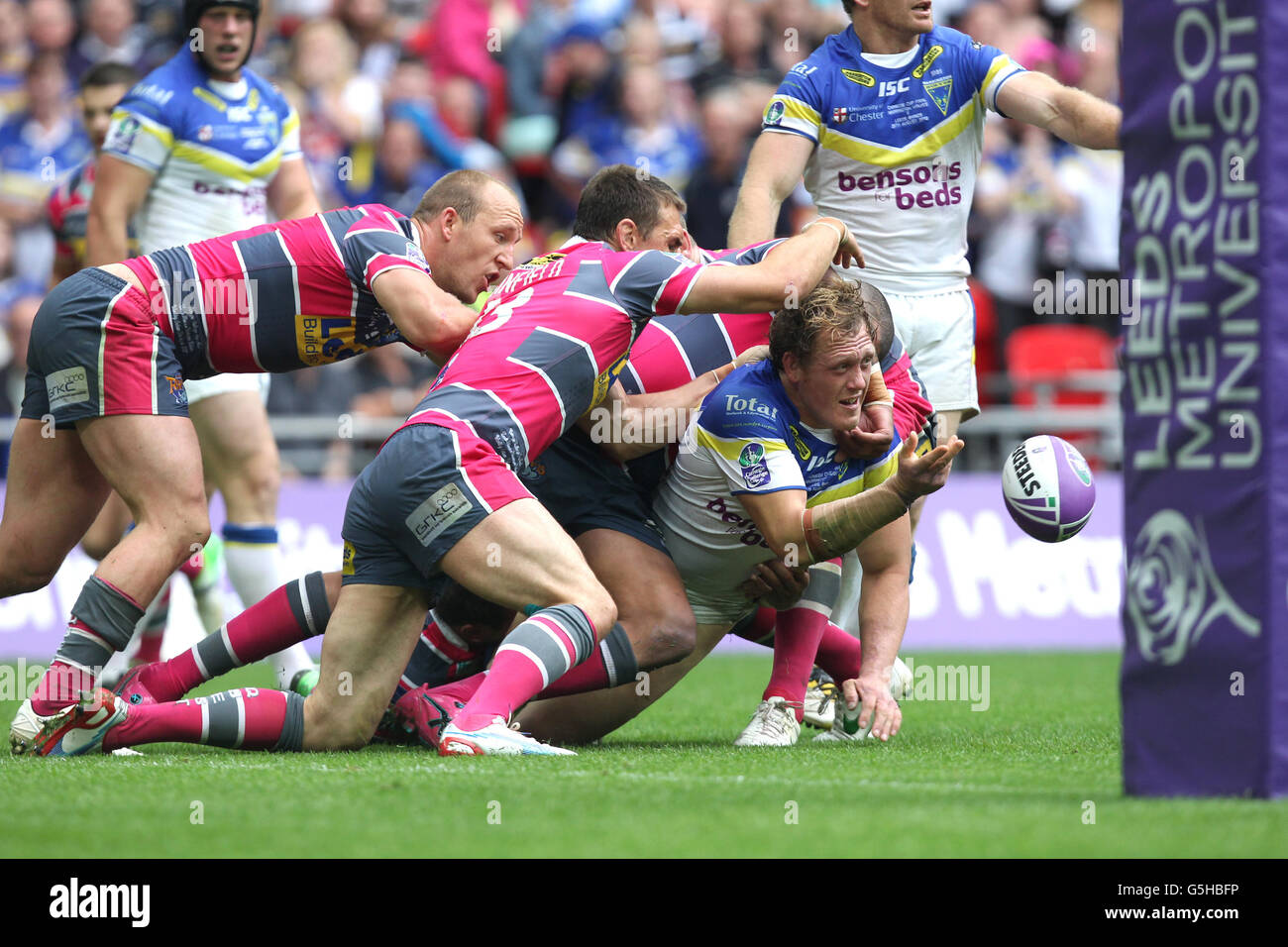 Warrington Wolves' Ben Westwood manages to pass despite tackles Stock ...