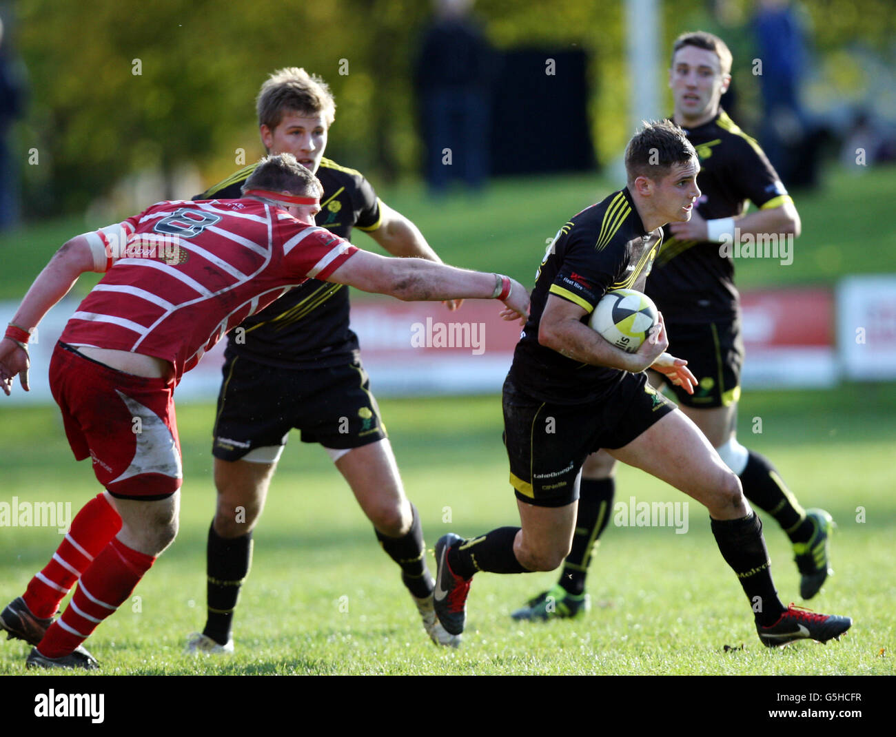 Melrose's Joe Helps (right) is tackled by Llandovery's Luke Kendall ...