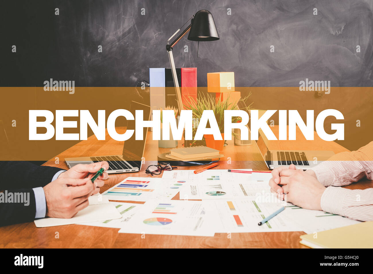 Two Businessman Benchmarking working in an office Stock Photo - Alamy