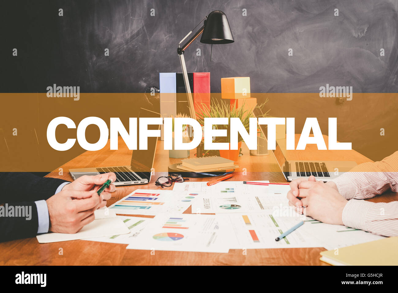 Two Businessman Confidential working in an office Stock Photo - Alamy