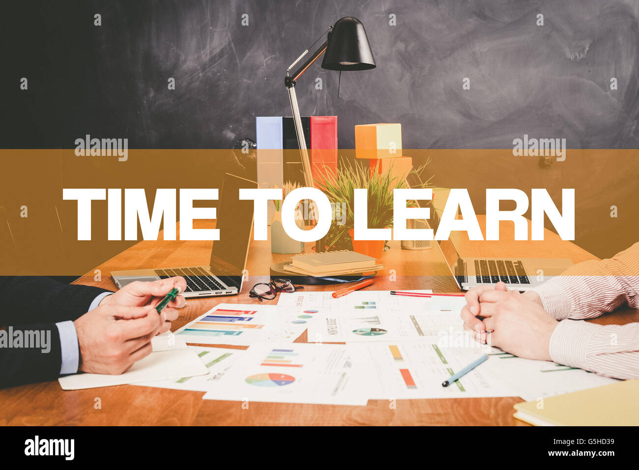 Two Businessman Time To Learn working in an office Stock Photo - Alamy