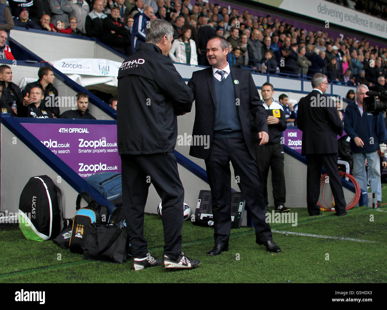 Manchester City assistant manager Brian Kidd (left) shakes hands with ...