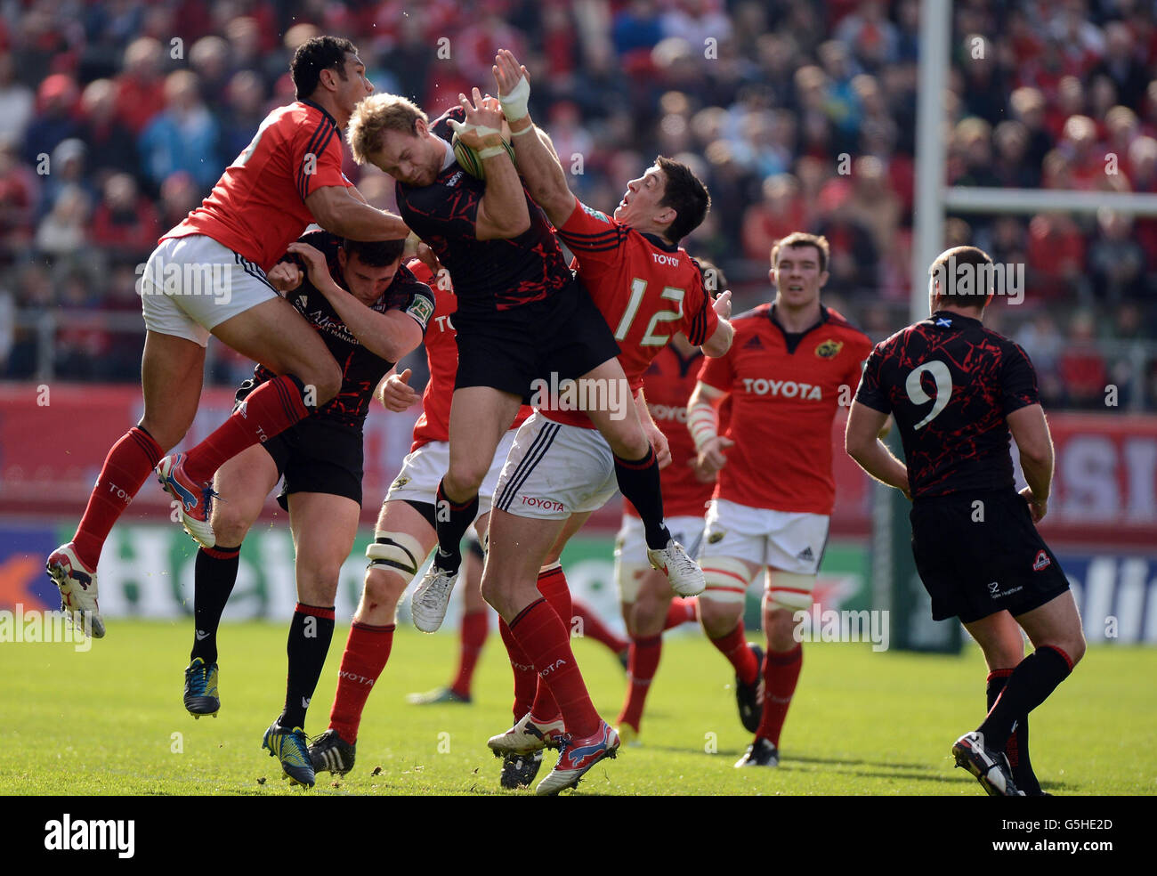 Edinburgh's Greig Tonks (centre left) is tackled by Munster's James ...