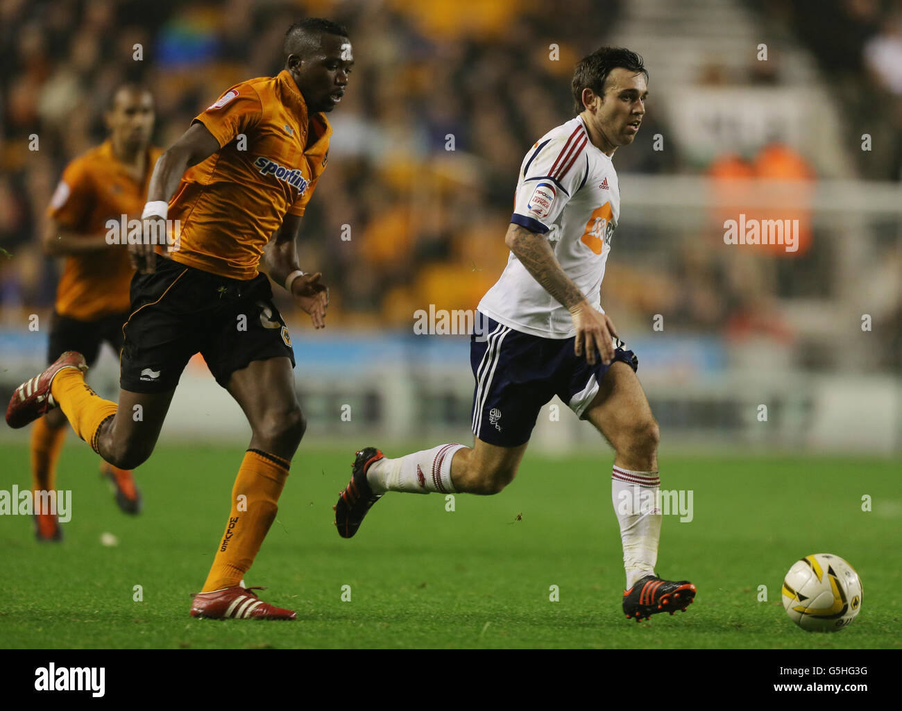 Bolton Wanderers' Mark Davies runs from Wolverhampton Wanderers Tongo ...