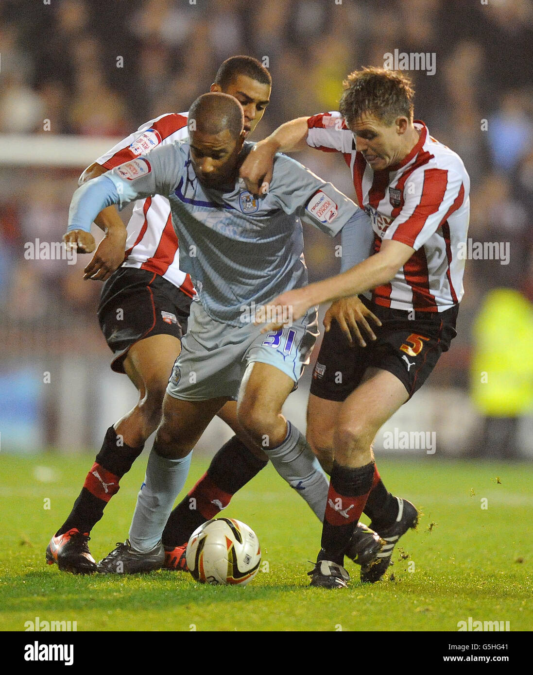 Coventry City's David McGoldrick (centre) and Brentford's Tony Craig ...
