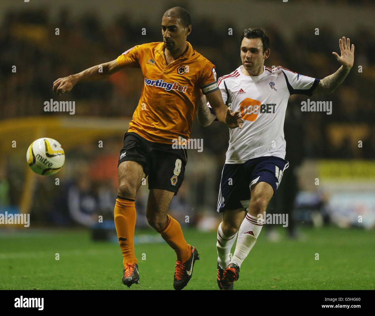 Wolverhampton Wanderers' Karl Henry holds off a challenge from Bolton ...