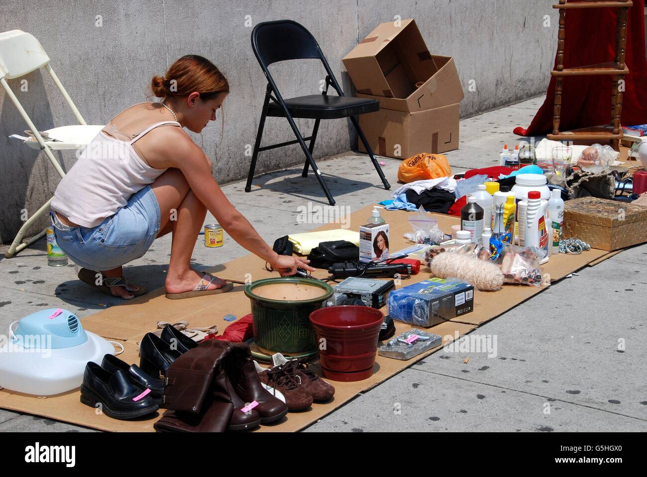 New York City: Young woman selling items from her apartment at a ...