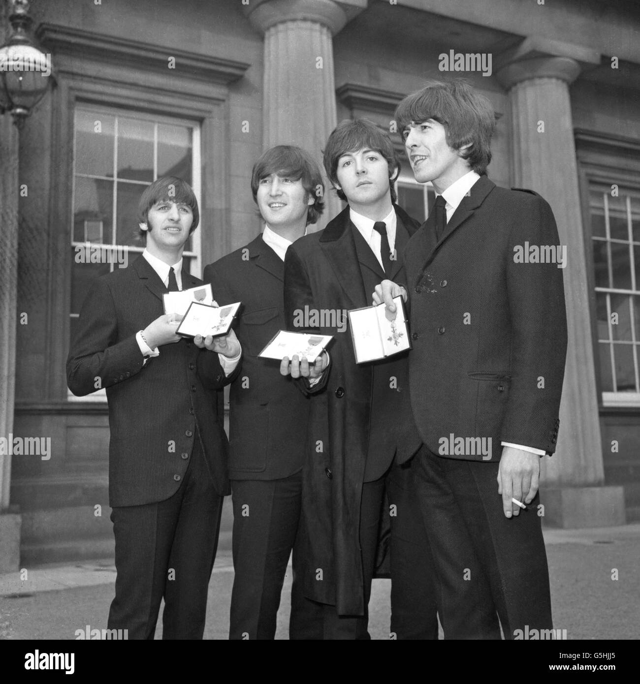 The Beatles recieve their MBE's from The Queen at Buckingham Palace ...