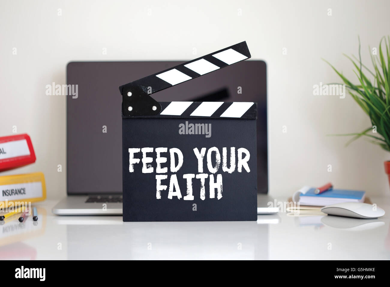 Cinema Clapper with Feed Your Faith word Stock Photo - Alamy