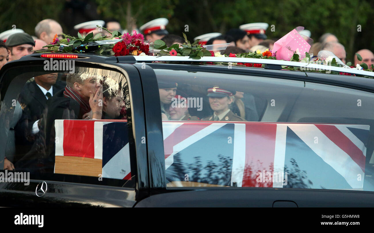 Mourners lay flowers on the hearse carrying Corporal Channing Day from ...