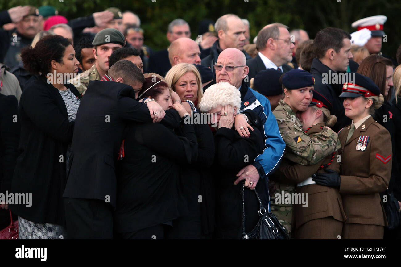 Mourners react after laying flowers on the hearse carrying Corporal ...