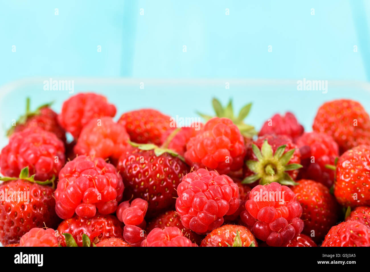 Raspberry And Strawberry Pile In Fruit Market Stock Photo - Alamy
