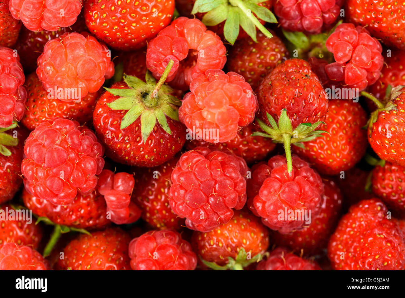 Raspberry And Strawberry Pile In Fruit Market Stock Photo - Alamy
