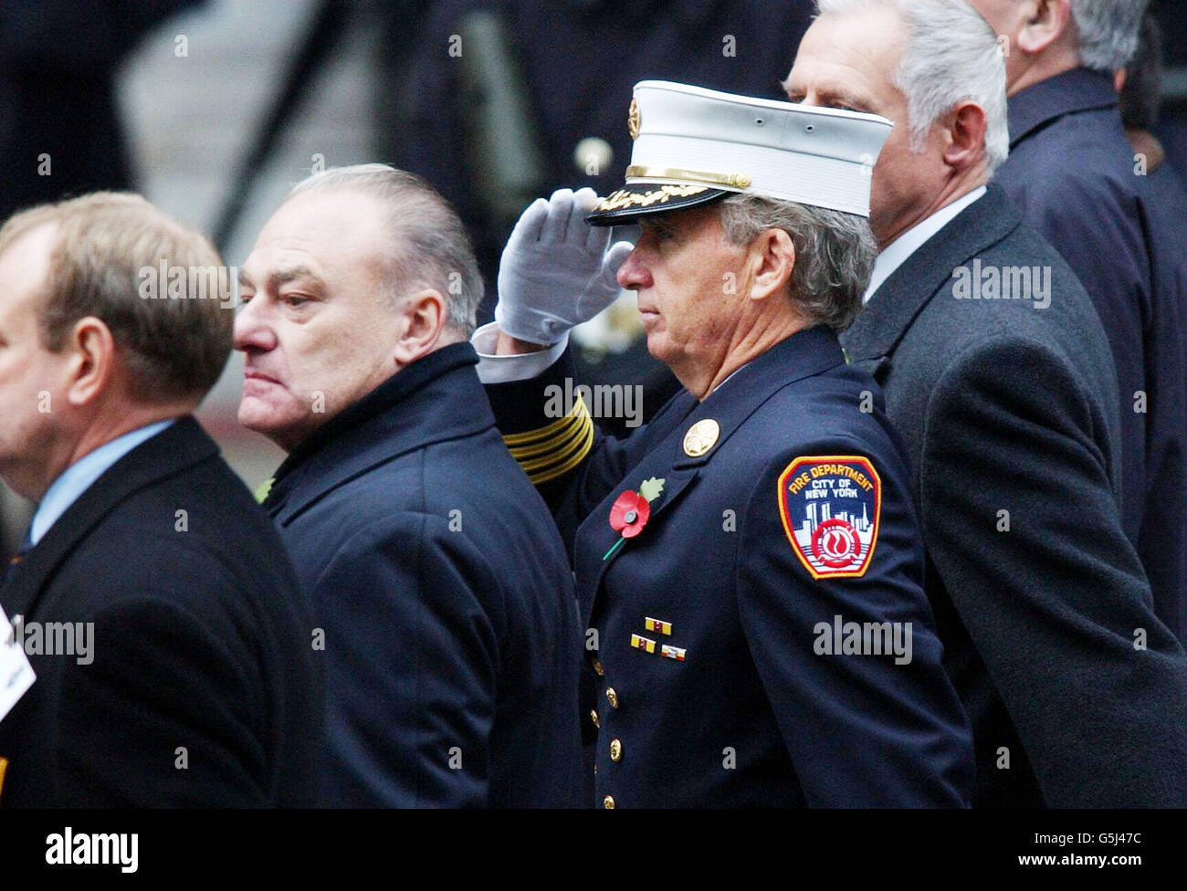 Chief of the New York Fire Department Joe Callan, salutes as he passes ...