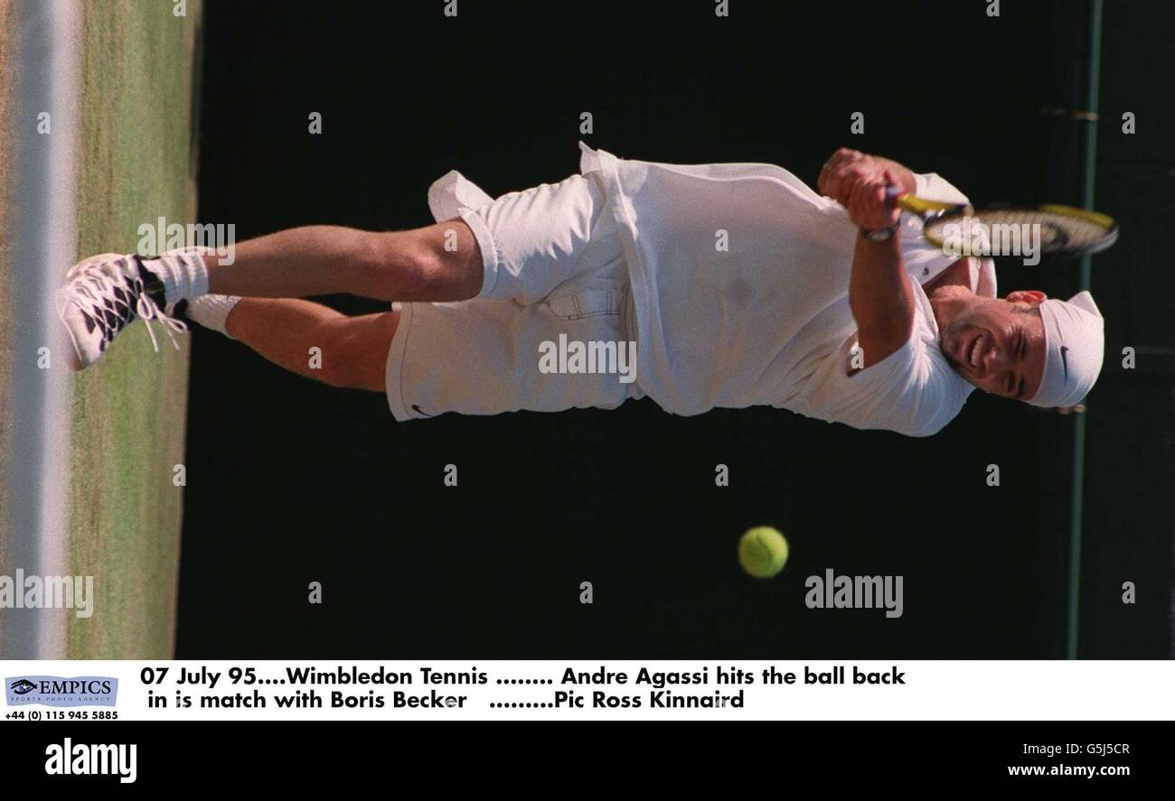 07 July 95. Wimbledon Tennis, Andre Agassi hits the ball back in is ...