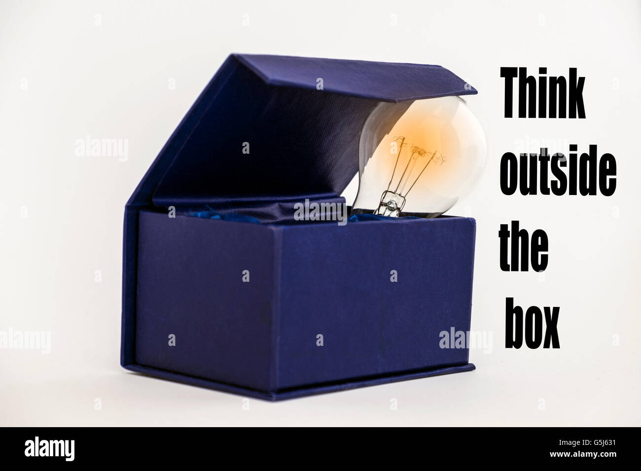 Blue box with glowing bulb and Think outside the box text on white ...