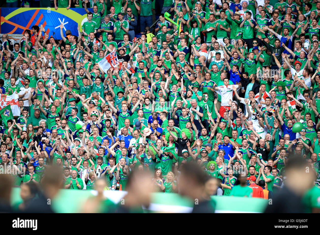 Northern Ireland fans cheer on their side in the stands as the players ...