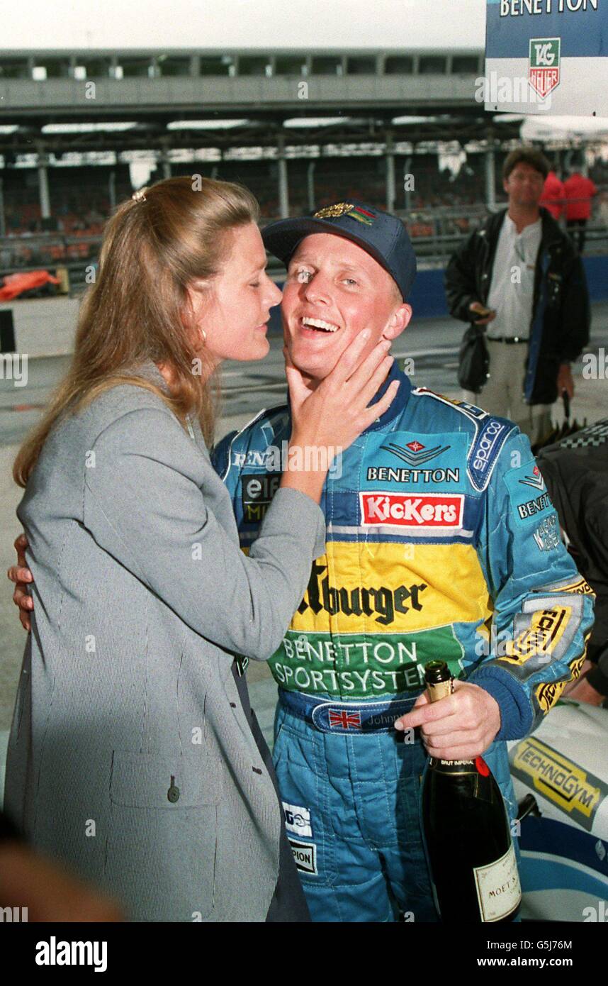 16-JUL-95, Johnny Herbert's wife Rebecca gives him a celebratory kiss ...