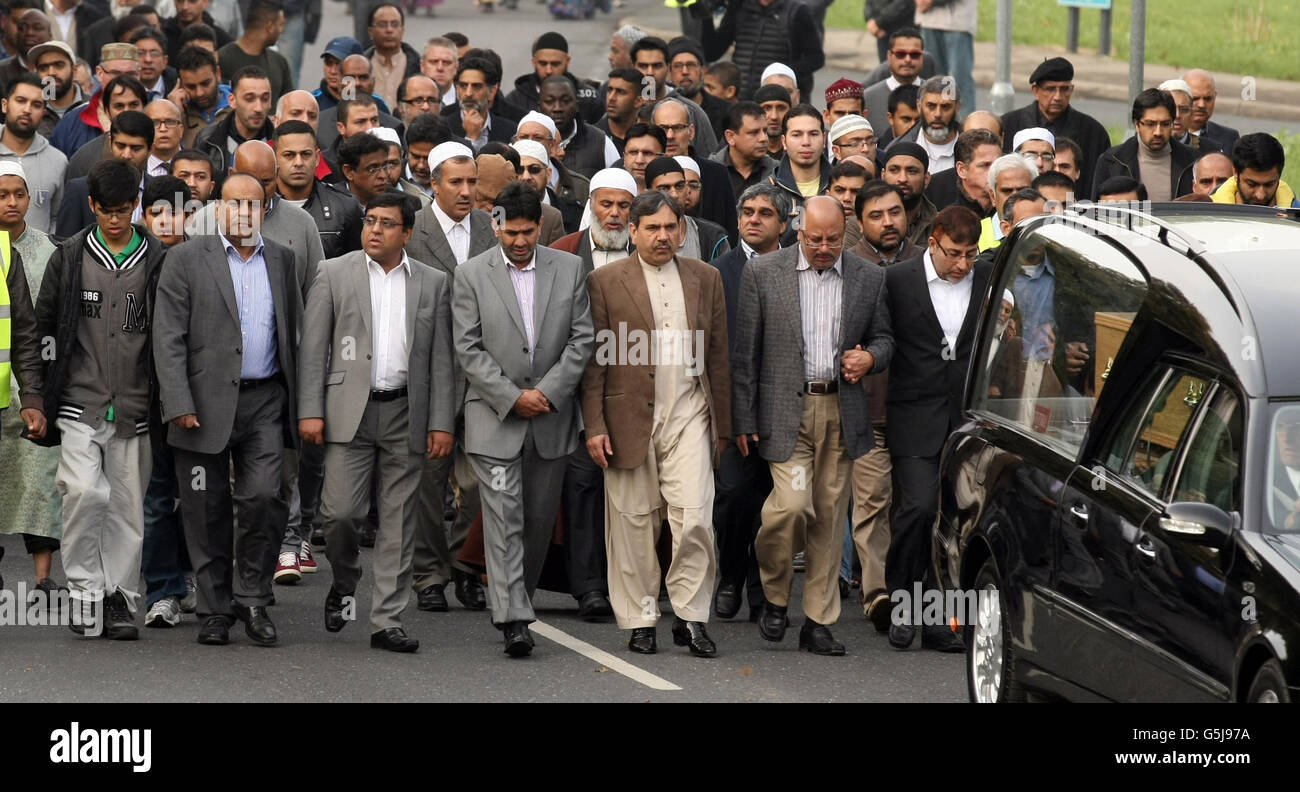 Dr Abdul Shakoor (front row, right) follows the funeral cortege of his ...