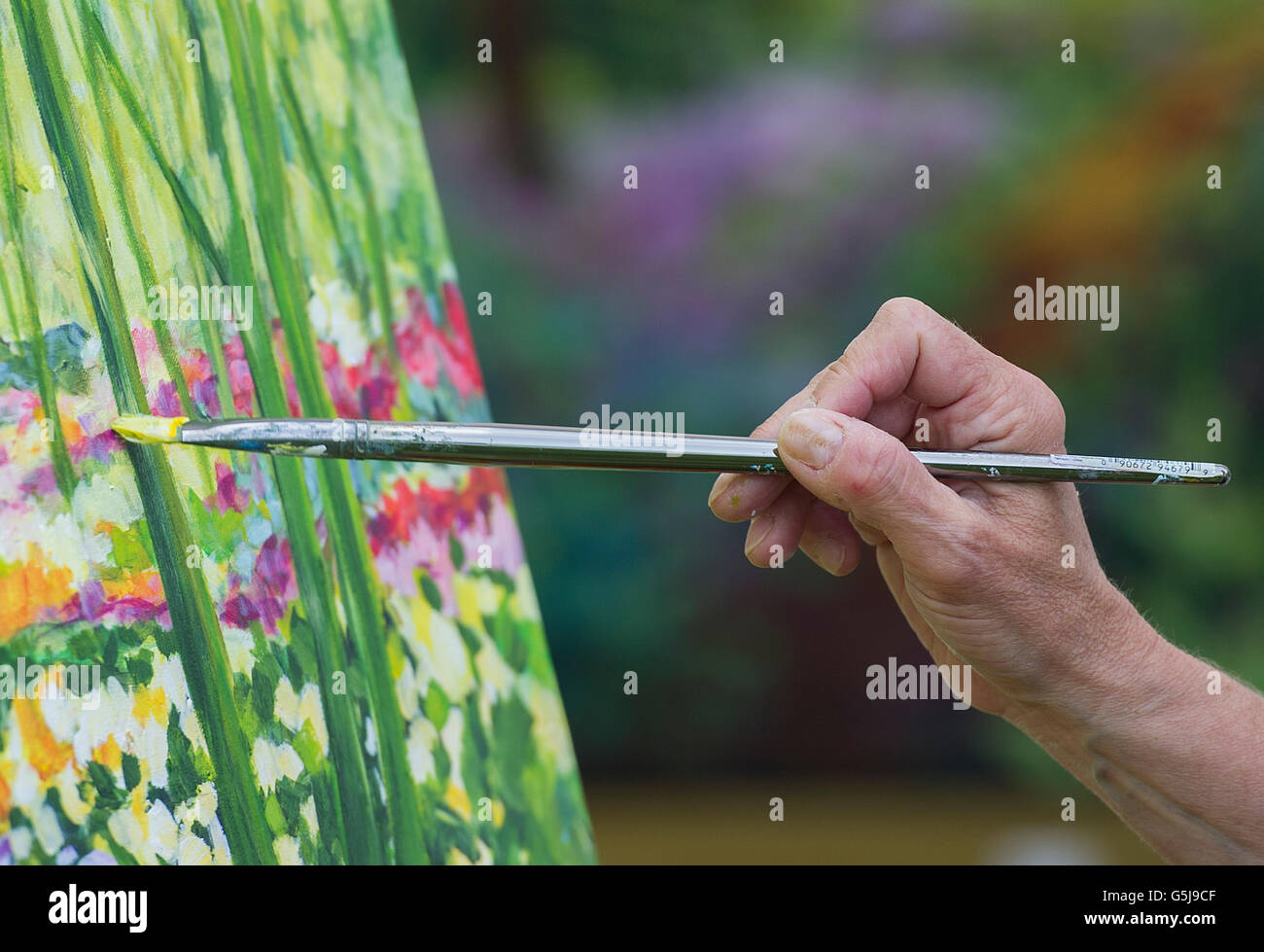 An artist puts the finishing touches to a piece during an artists ...