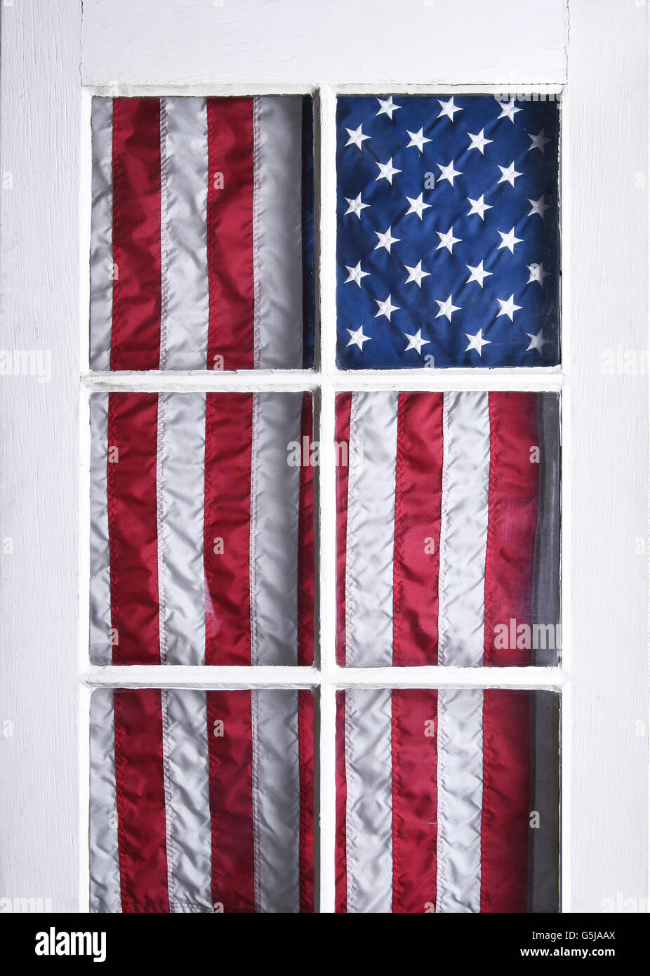 American Flag hanging on the inside of a glass panel door to celebrate ...