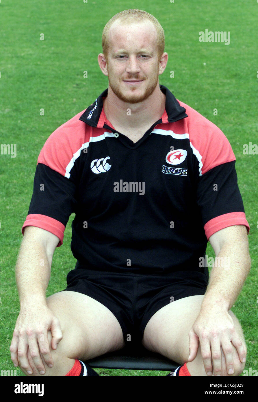 Sport rugby union seated smiling hands on knee hi-res stock photography ...
