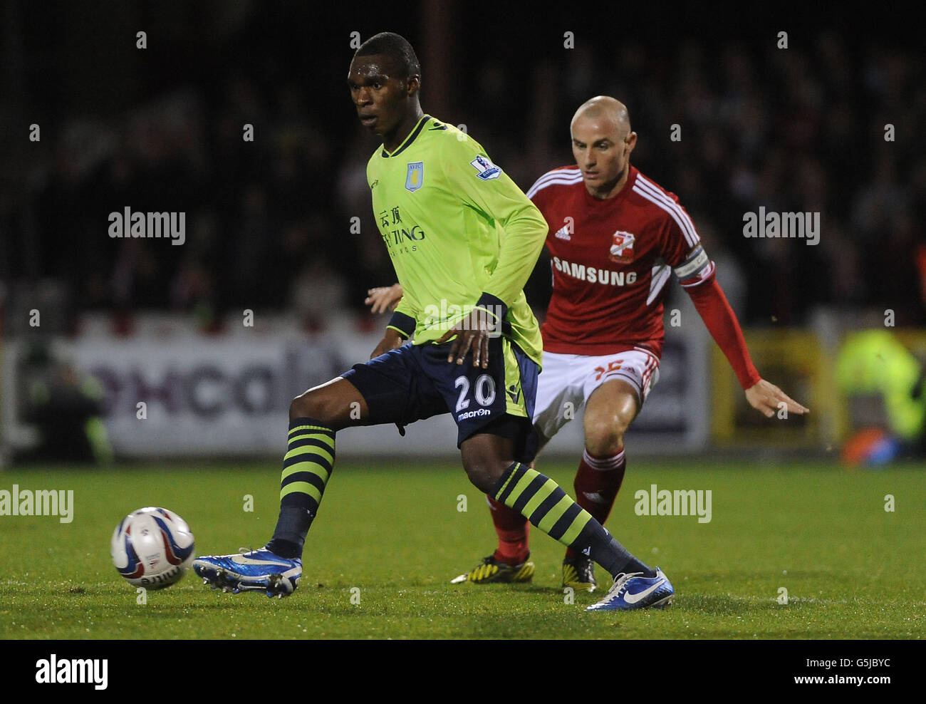 Swindon Town's Alan McCormack and Aston Villa's Christian Benteke ...