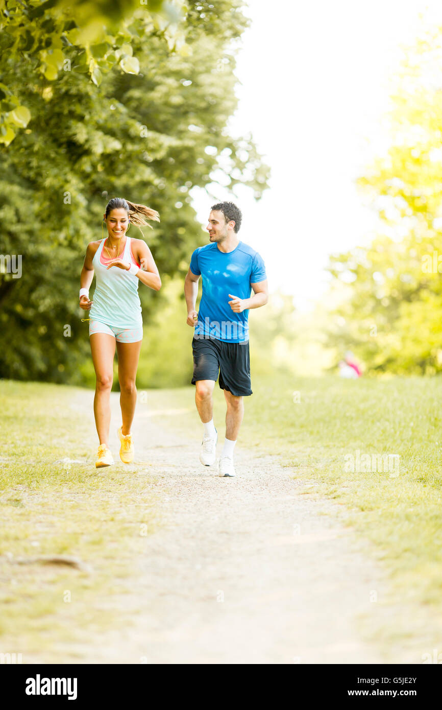 Photo of happy couple running in the morning outdoors Stock Photo - Alamy
