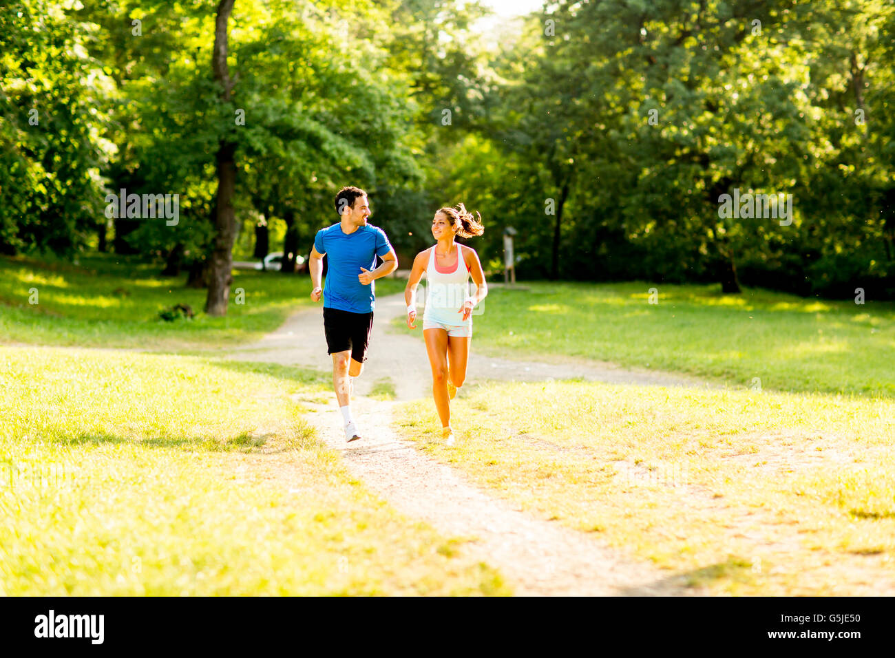 Photo of happy couple running in the morning outdoors Stock Photo - Alamy